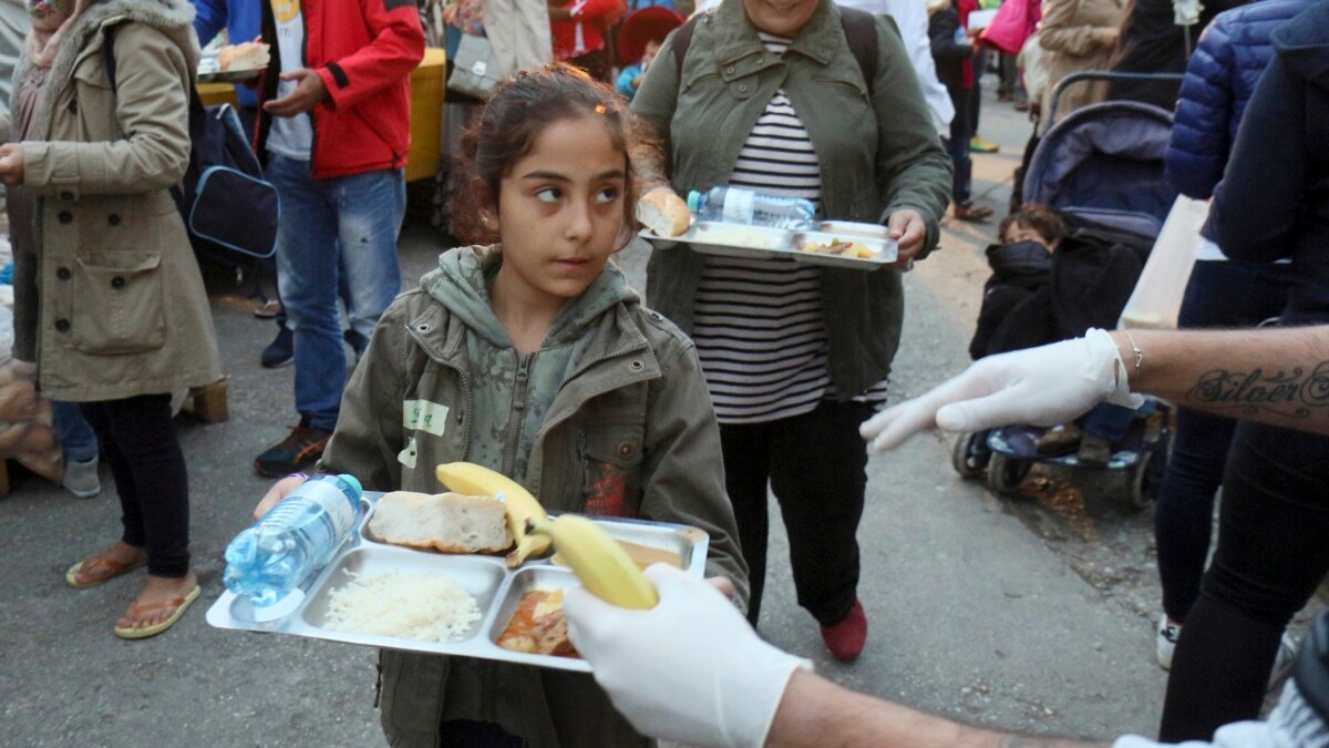At Austrian Refugee Camp Volunteers Rush In